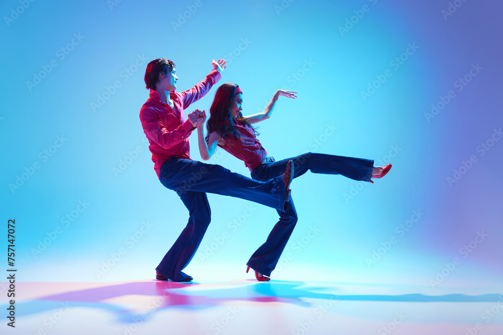 Happy, positive young man and woman in retro clothes dancing boogie ...