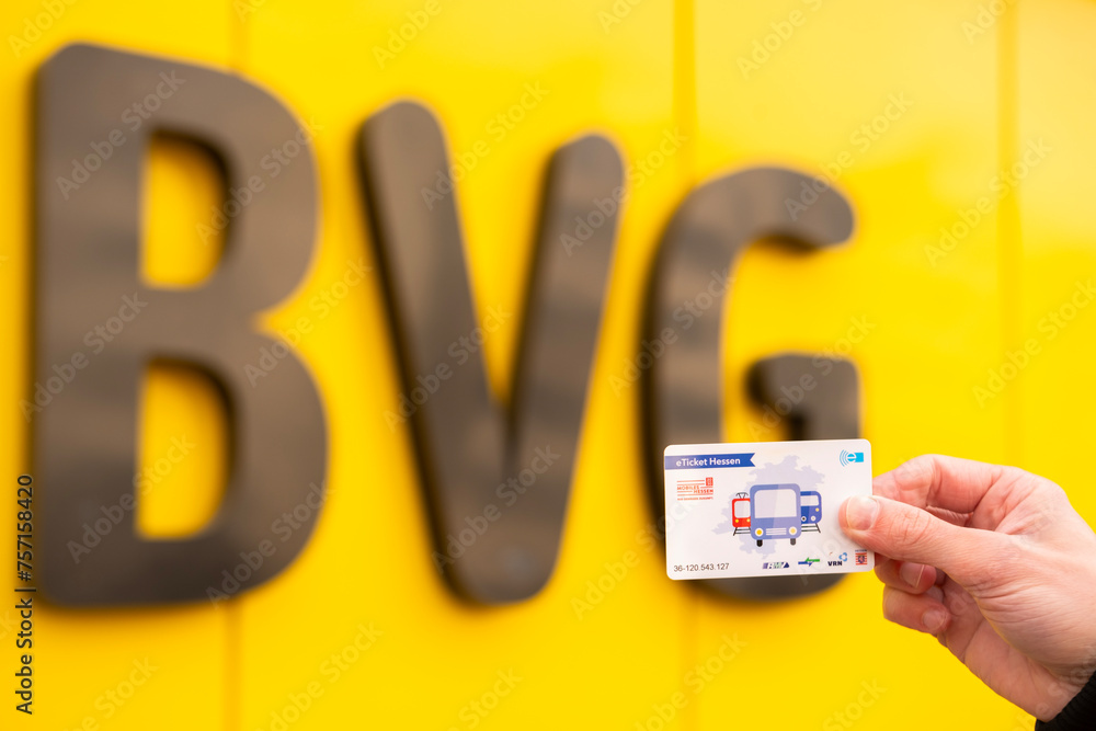 male hand hold electronic Deutschland-Ticket, BVG logo Berliner ...