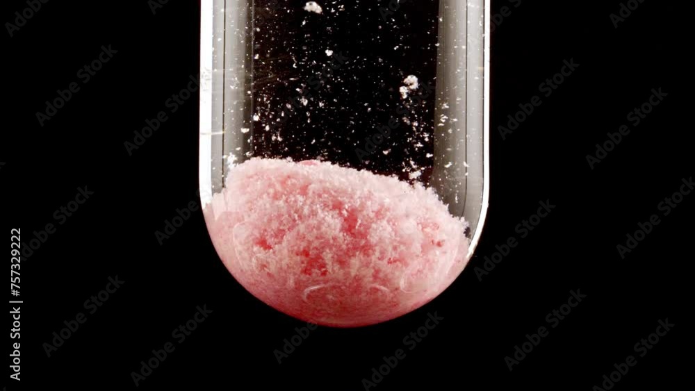 Effervescent pink tablet aspirin. Macro shot of fine air bubbles rising ...