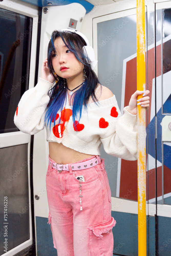 Trendy Gen-Z chinese girl with blue hair in urban setting Stock Photo ...