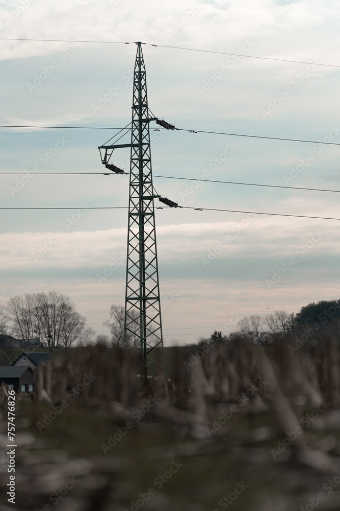 Big powergrid pylon antenna with thick electricity wires standing on ...