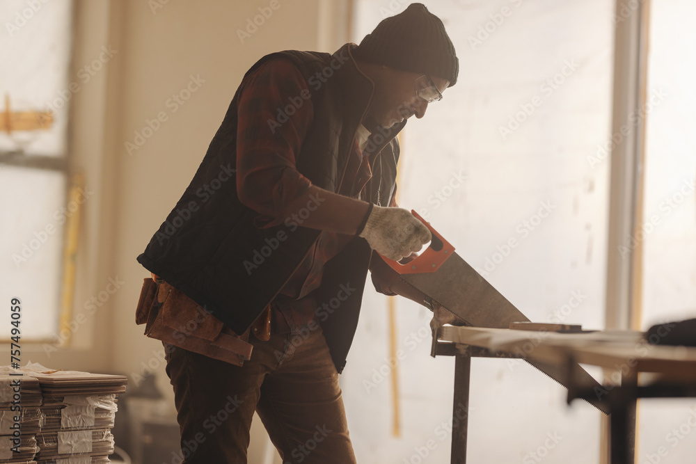 Skilled worker redesigning and upgrading an interior kitchen with wood ...