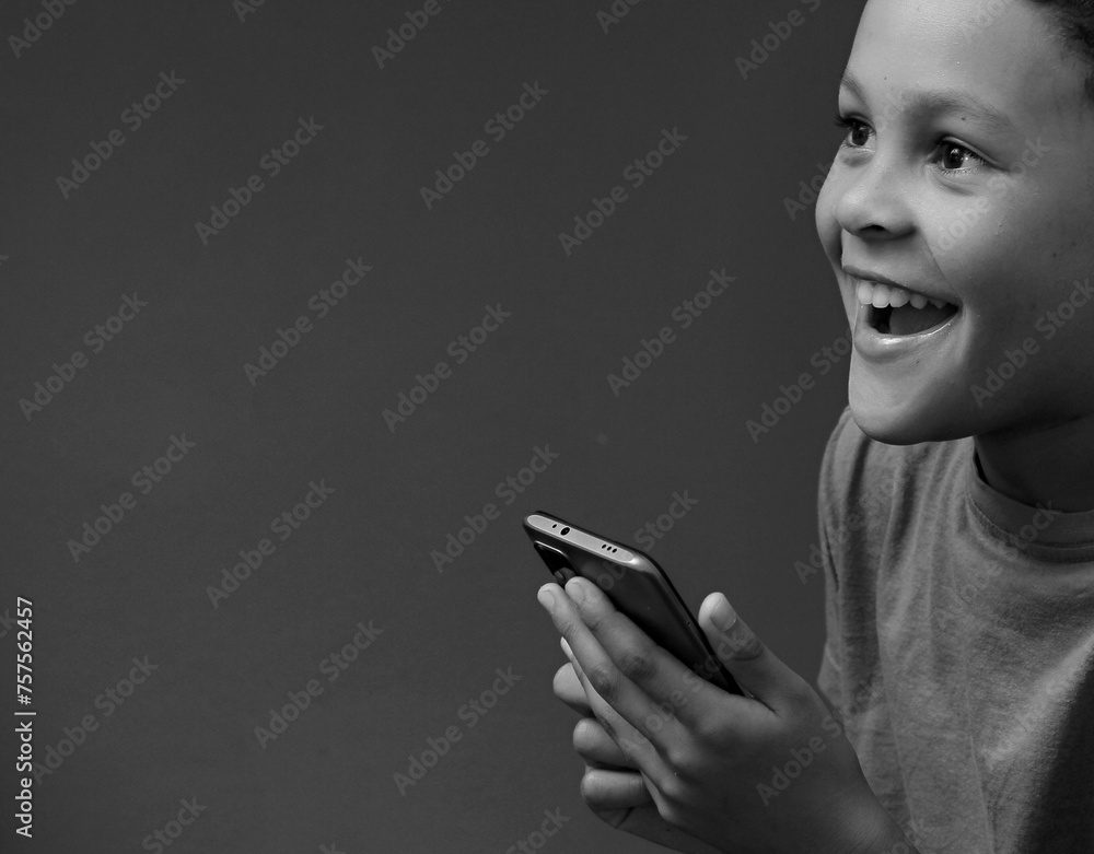boy with mobile phone calling home on his mobile phone with grey black ...