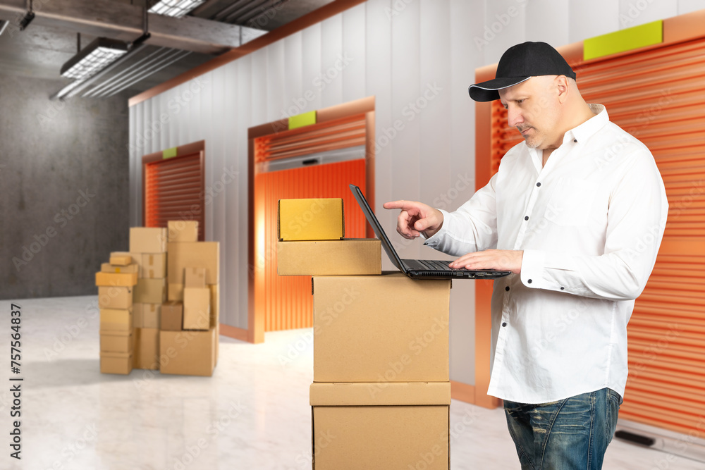 Man is standing near storage unit. Businessman rents warehouse. Guy ...