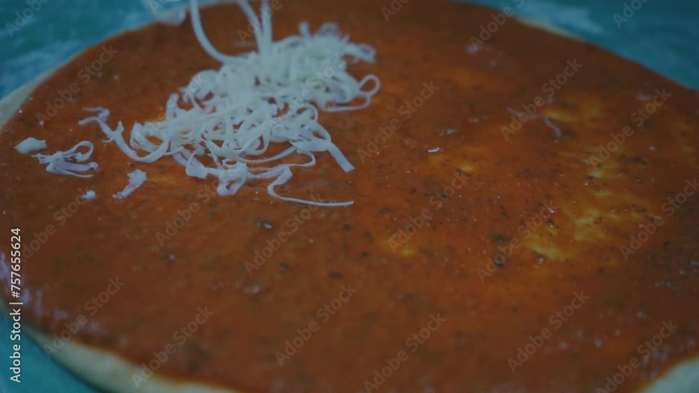 Watch as mozzarella cheese falls in molten threads onto a base of red ...