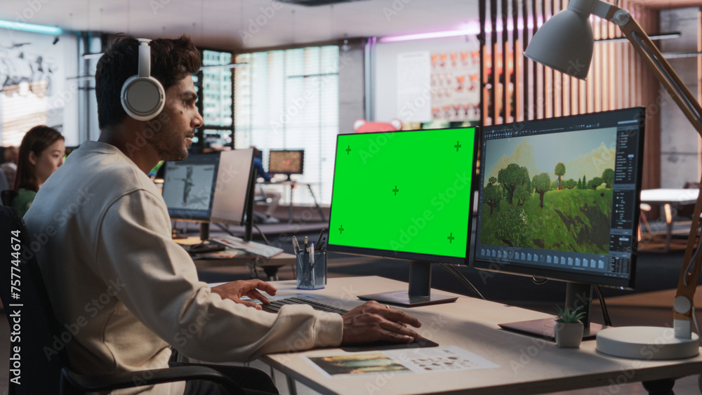 Indian Male Game Designer Using Desktop Computer With Green Screen ...