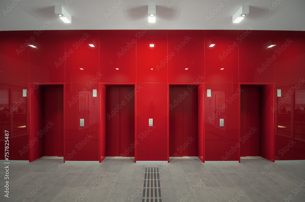 Four elevator doors in a red wall. Two dimensional image of gloss red ...