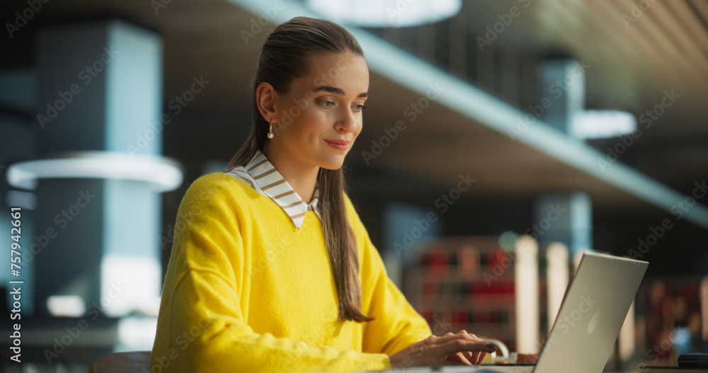 Excited Young Female is Focused on Creating an University Presentation ...