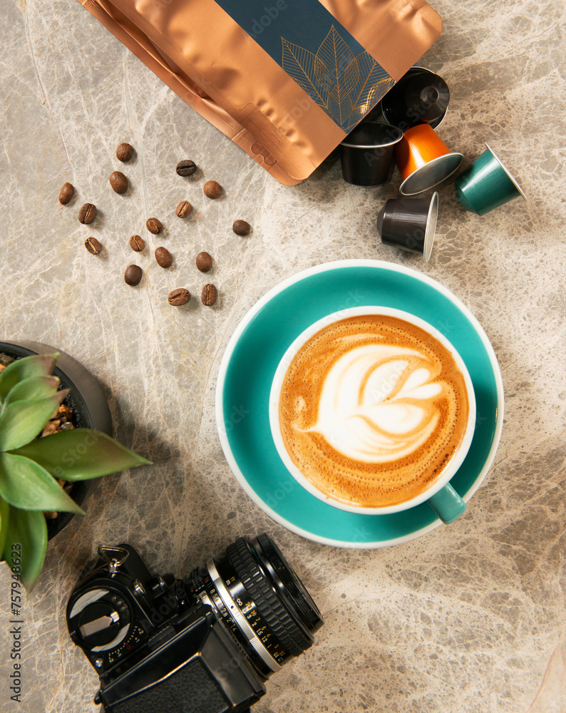 Cup of cappuccino with capsules and grains of coffee around. Beautiful ...