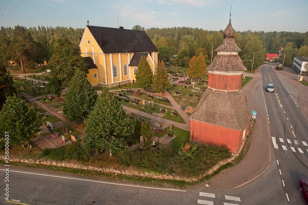 Aerial view of old yellow wooden church of Pusula and red bell tower ...