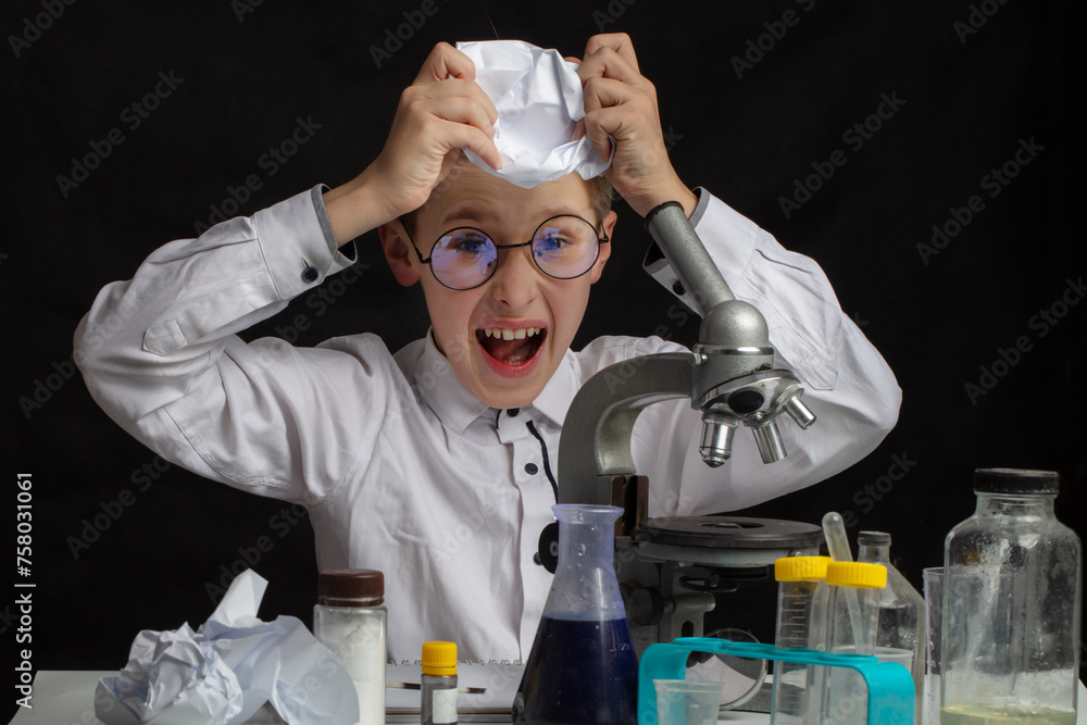 The boy is a scientific researcher with a microscope doing experiments ...