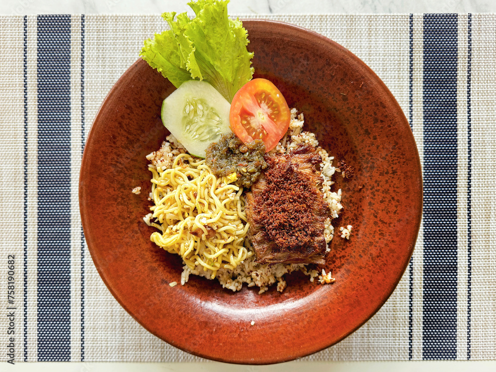 Traditional modern Indonesian food. Smashed seasoned beef with noodle ...