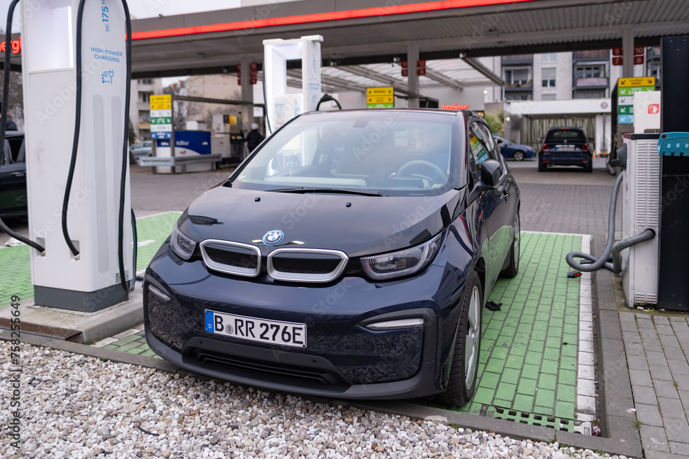 BMW i3 electric car is being charged from an electric charging station ...