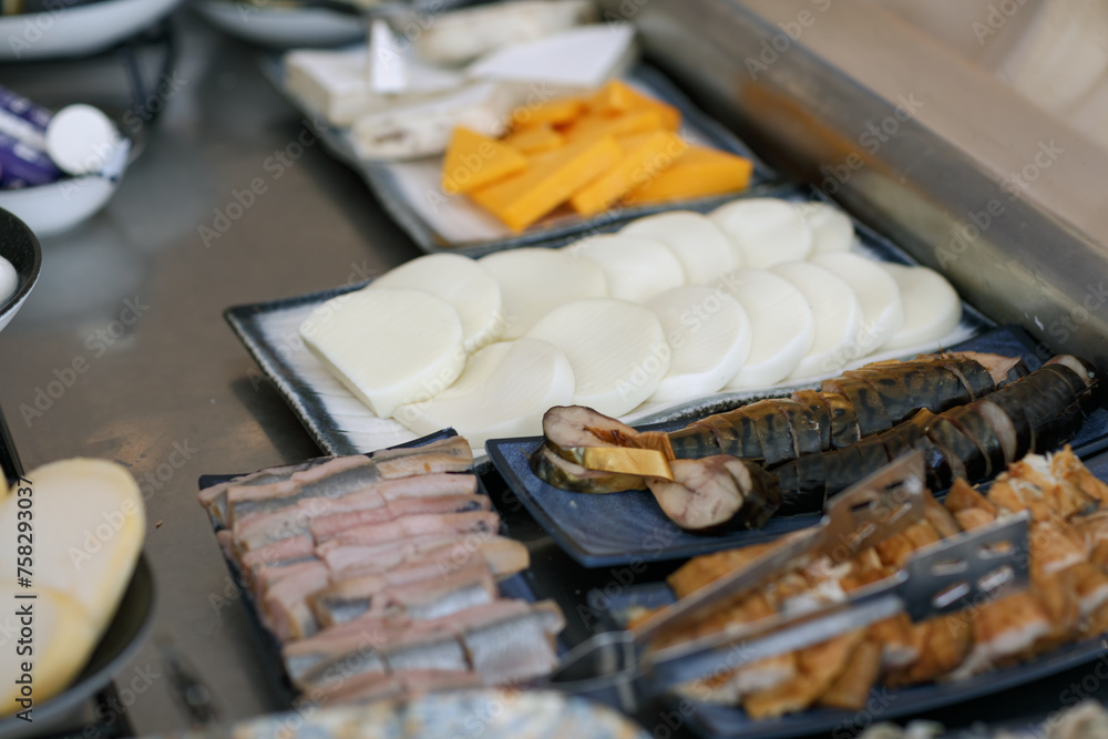 Stockfoto a variety of cheeses and fish arranged on trays. The ...