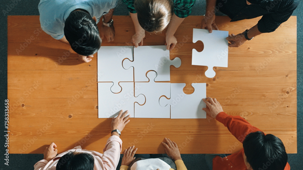 Top down view of skilled business people assemble jigsaw puzzle on ...