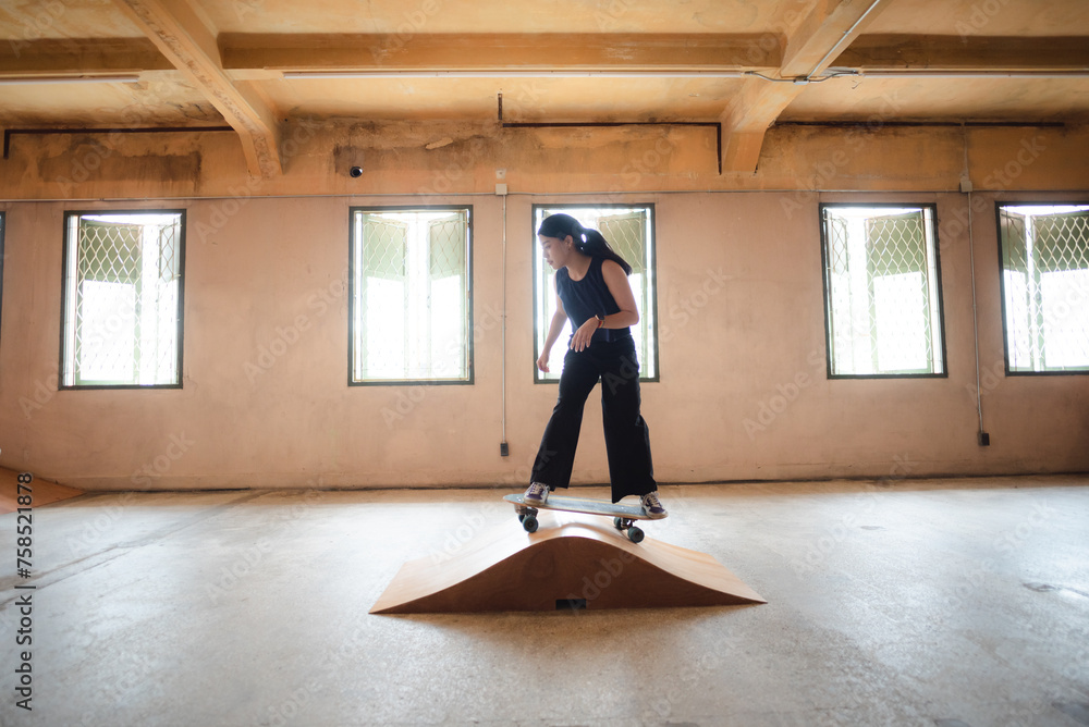 skater woman person playing skateboard in sport gym, young Asian woman ...