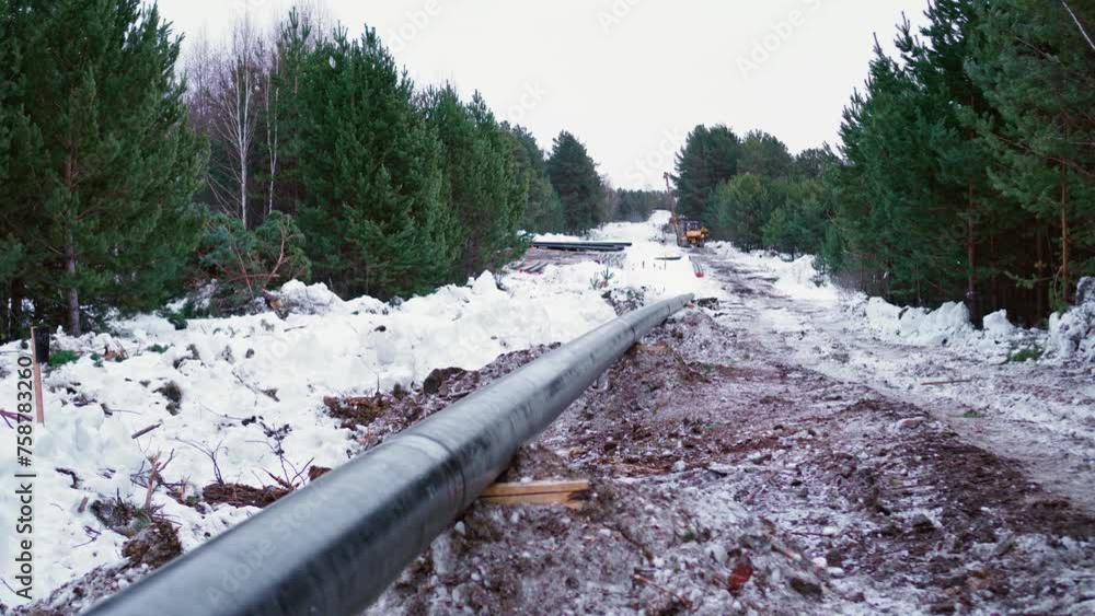 Laying a new gas pipeline line in winter. A large diameter gas pipeline ...