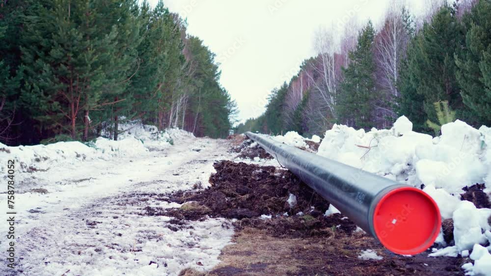 Laying a new gas pipeline line in winter. A large diameter gas pipeline ...