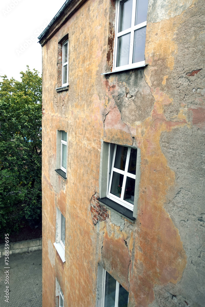 Angle of building wall in bad condition with some new plastic windows ...