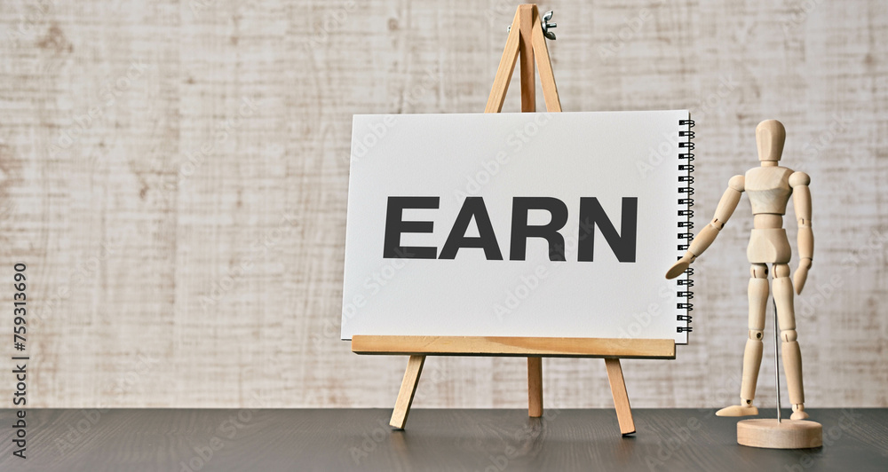 There is notebook with the word EARN. It is as an eye-catching image ...