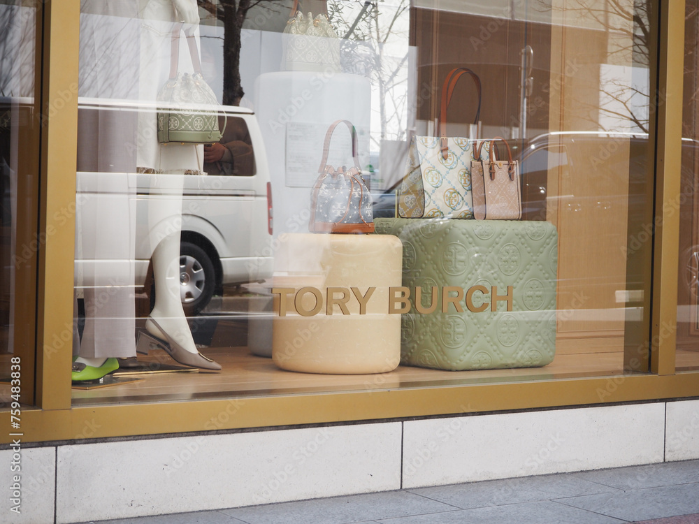 TOKYO, JAPAN - March 16, 2024: Display in the window of a Tory Burch ...
