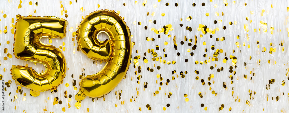 Golden foil balloon number, figure fifty-nine on white with confetti ...
