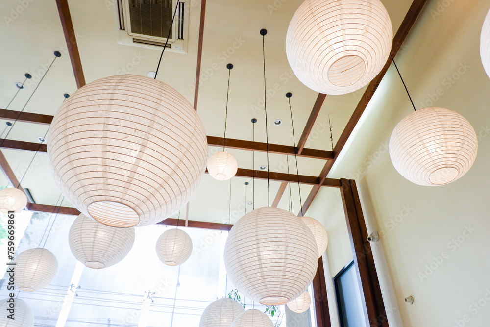 Traditional asian white paper lantern on the ceiling in living room at ...