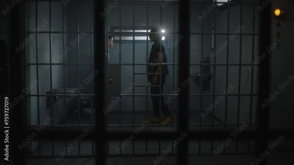 Multi ethnic teen prisoners fight in prison cell. Young criminal pushes ...