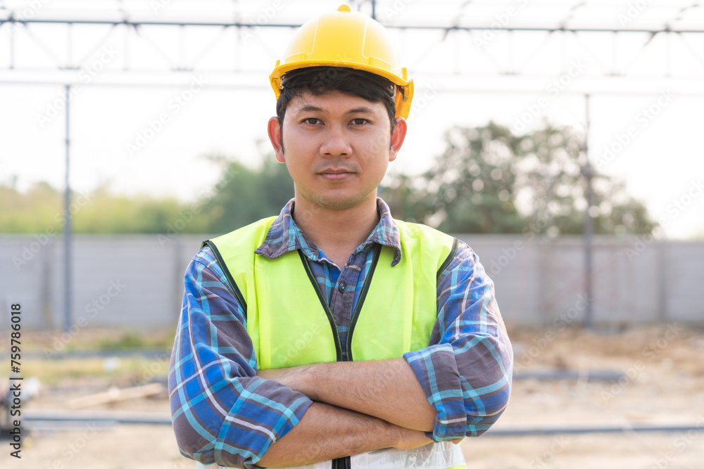 Asian young man, male contractor standing with arms crossed in jacket ...