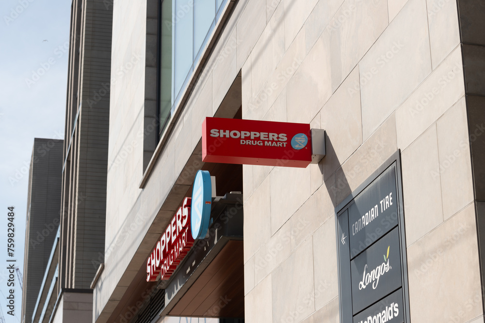 projecting sign of Shoppers Drug Mart, a ubiquitous pharmacy and food ...