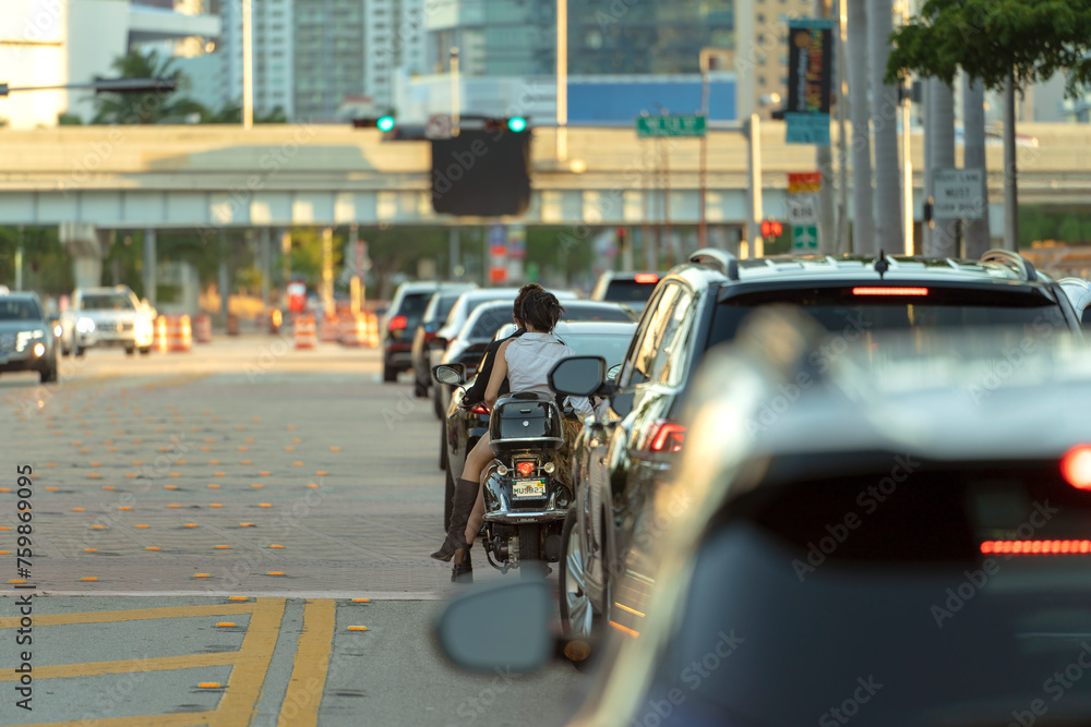 Motorcycle and cars traffic driving at intersection on American street ...
