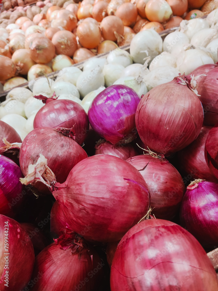 Onion vegetables in fresh produce section of grocery store or farmers ...