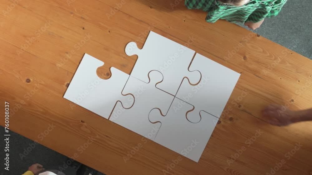 Top view of business man gathering last piece of jigsaw to complete ...