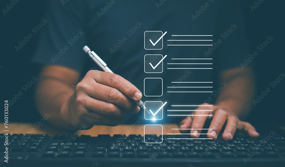 Checklist concept, Businessman using desktop computer and checking mark ...