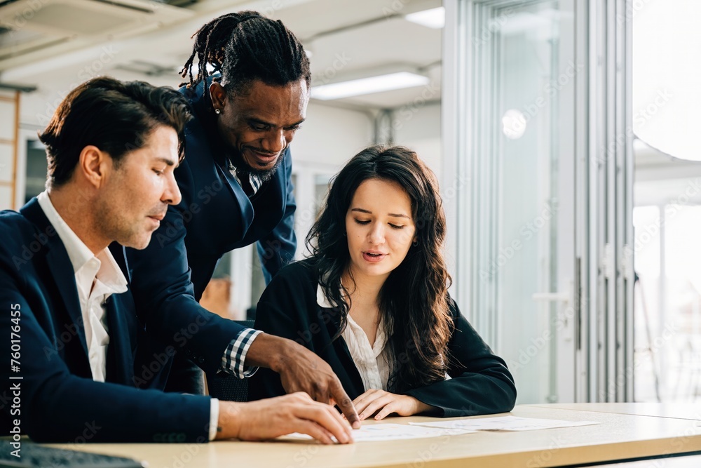 In a meeting, CEO and colleagues collaborate on research, planning, and ...