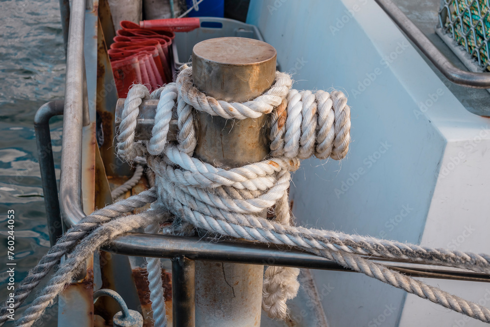 Photograph of white rope wrapped around a steel boat mooring bollard on ...