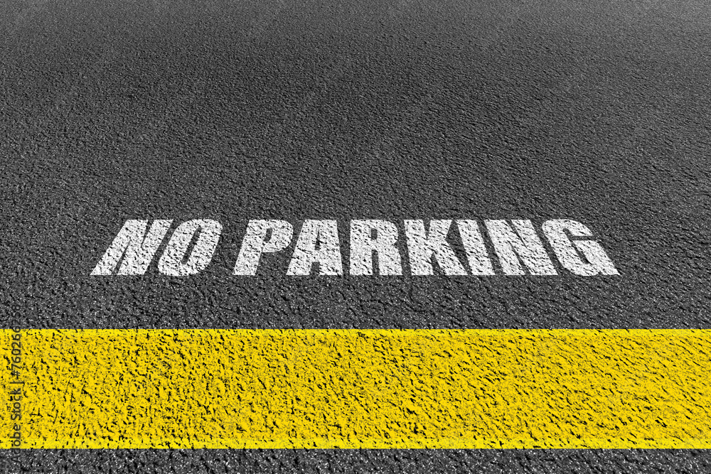 No parking signage on a concrete floor.No Parking Sign on the road ...