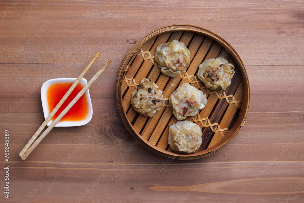Various Dim Sum in Bamboo Steamed container served with tomato sauce ...