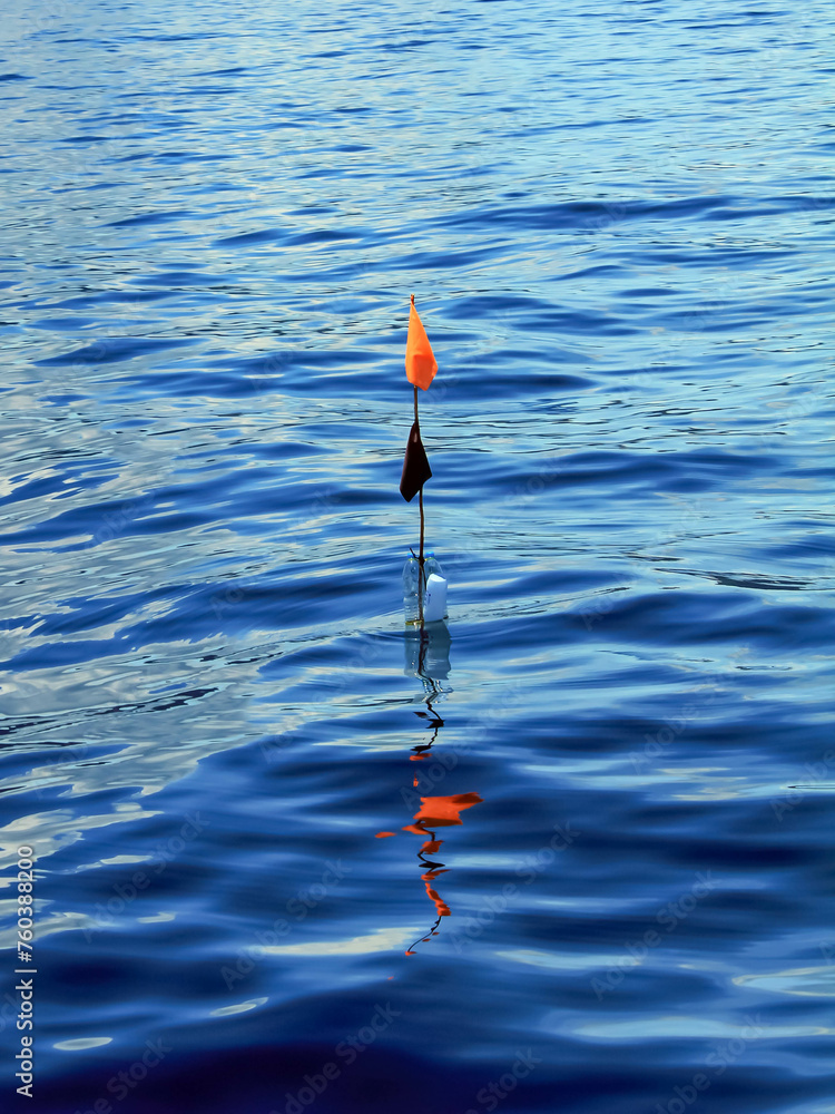 Ship sign buoy with flag in the middle of the sea. To notify danger ...