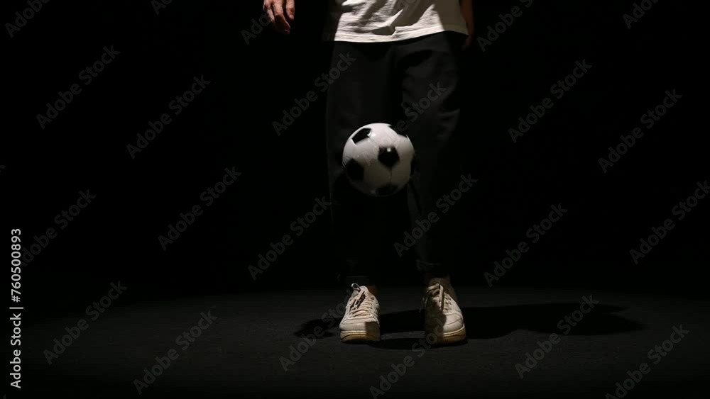 A football player kicks a soccer ball, waist-high angle. A guy juggles ...