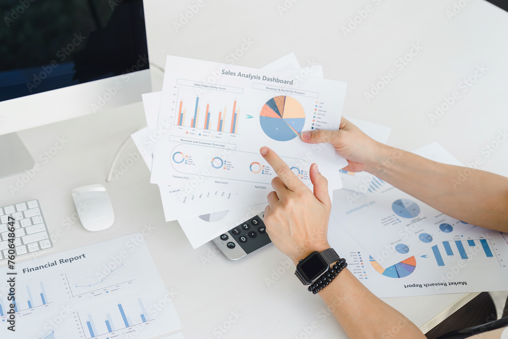 Hands of a professional examining a global market analysis report with ...