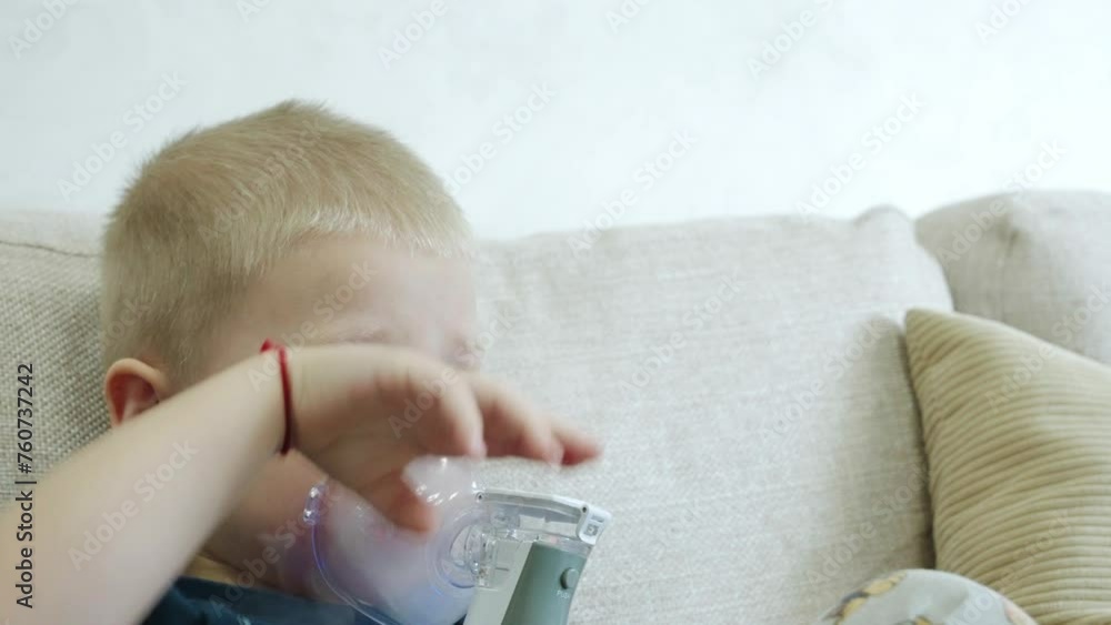 Little cute sick boy crying while doing inhalation at home. Portrait of ...
