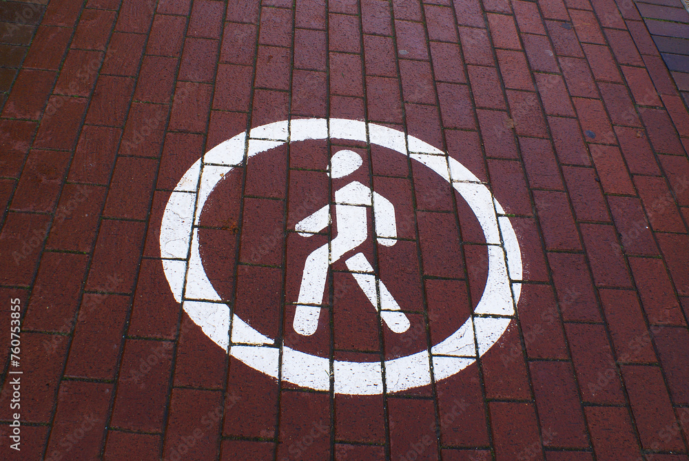 Road markings painted with white paint. Signs on the sidewalk and road ...