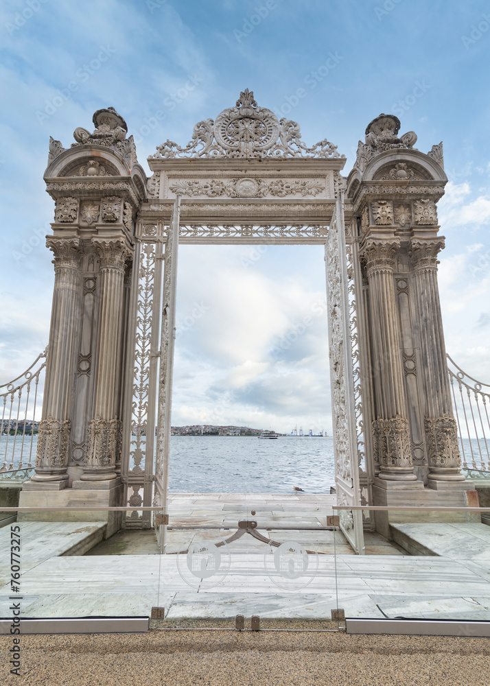 Pair of elaborately decorated white painted metal gates leading to the ...