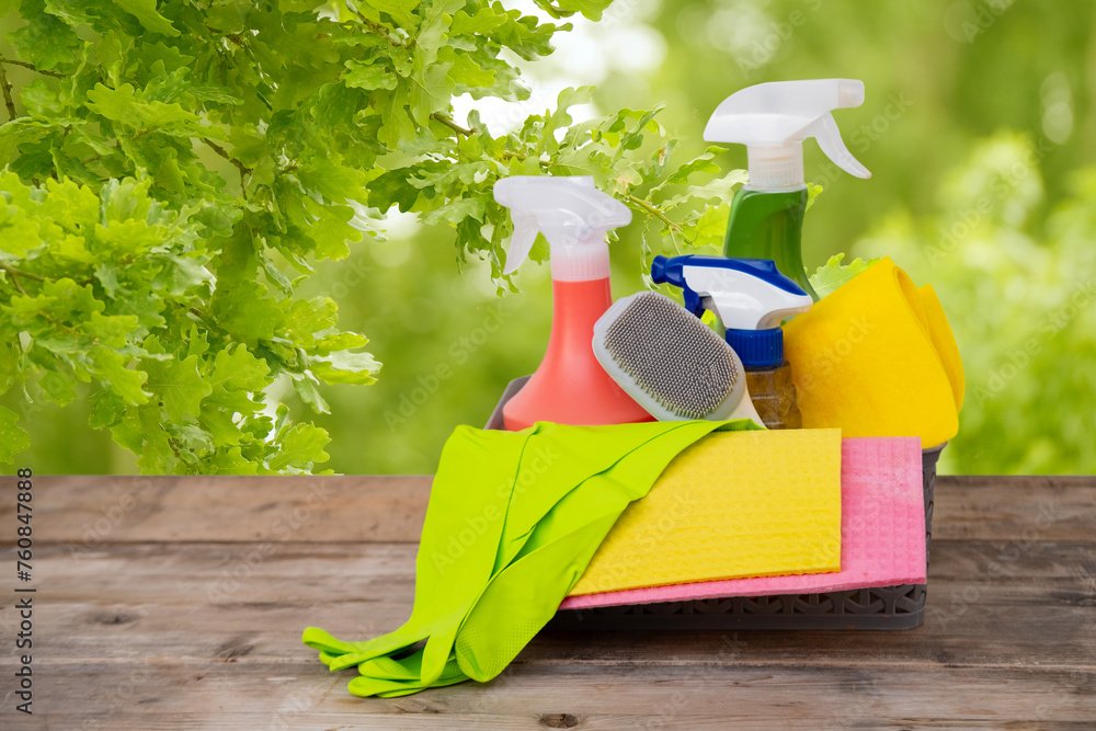 Basket with cleaning items on blurry spring background, spring home ...