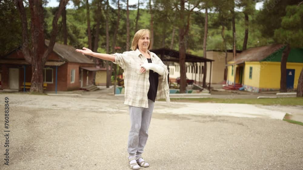Senior elderly woman doing exercises and gymnastic for hand with injury ...