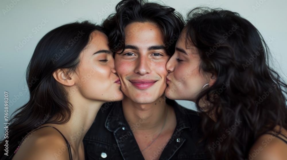 Two brunette women kissing brunette man on the cheeks. Concept of love ...