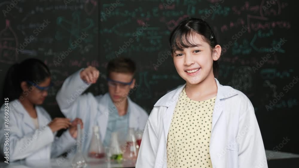 Cute asian scientist smile to camera while diverse group doing ...