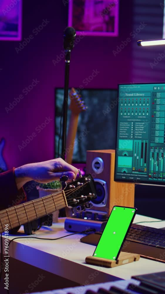 Vertical Video Artist learning to tune his acoustic guitar with app ...