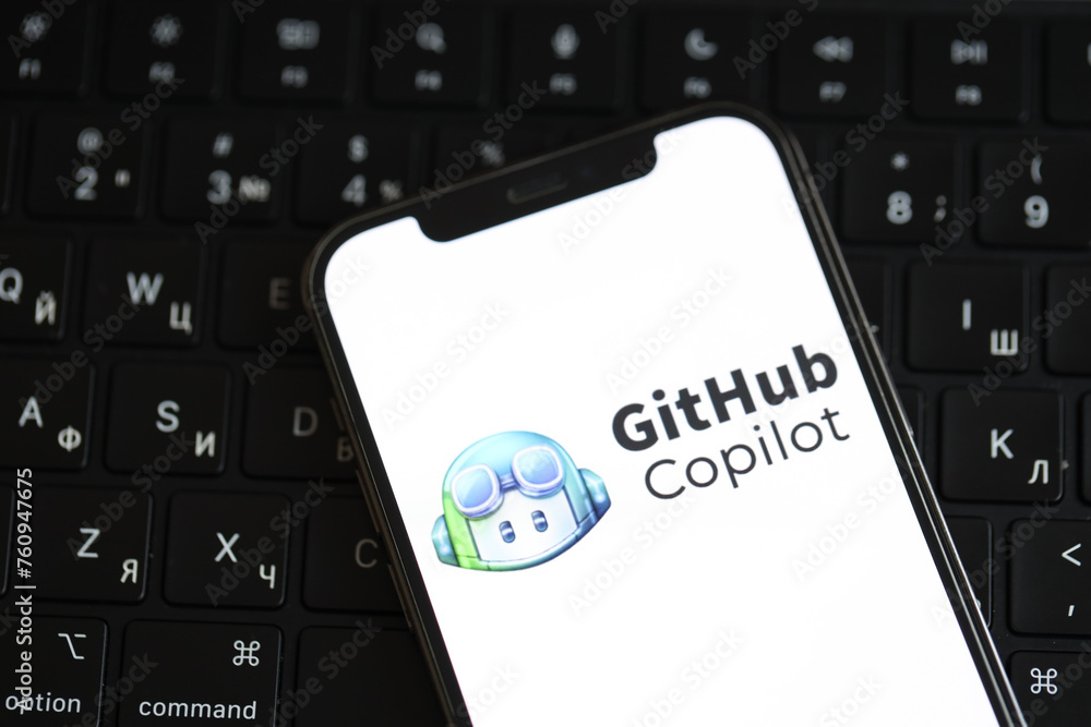 Foto de KYIV, UKRAINE - MARCH 17, 2024 Github copilot logo on iPhone display screen and MacBook ...
